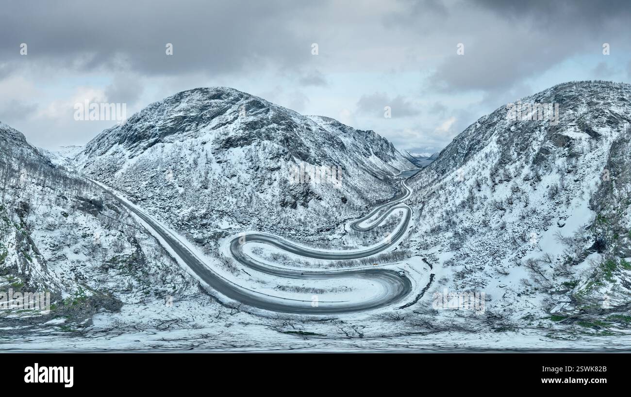 aerial photo of a snowy winding mountain pass road down to Sifjord on ...