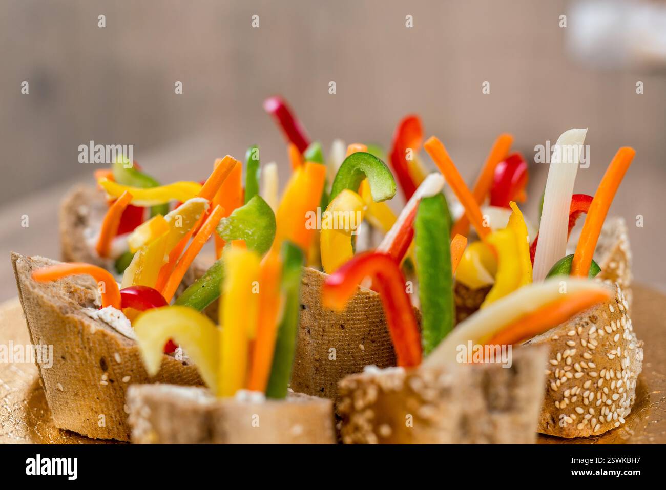 Colorful vegetable sticks inserted into sliced bread creating a vibrant ...