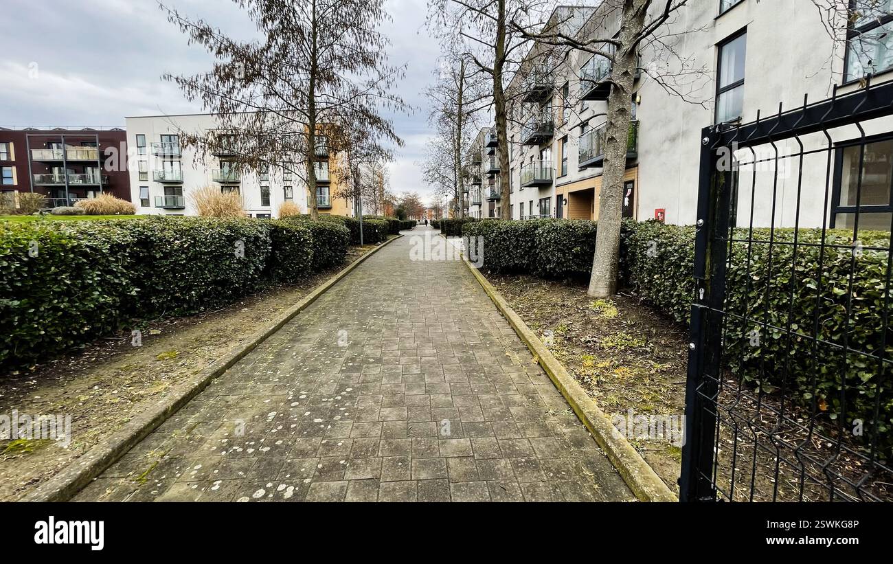 Pathway in Enfield, London, UK, with apartments and trees under an ...