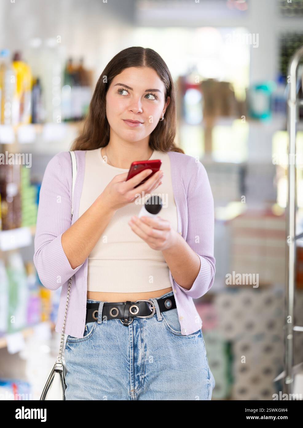 Checking expiration date of body deodorant - female shopper scans QR ...