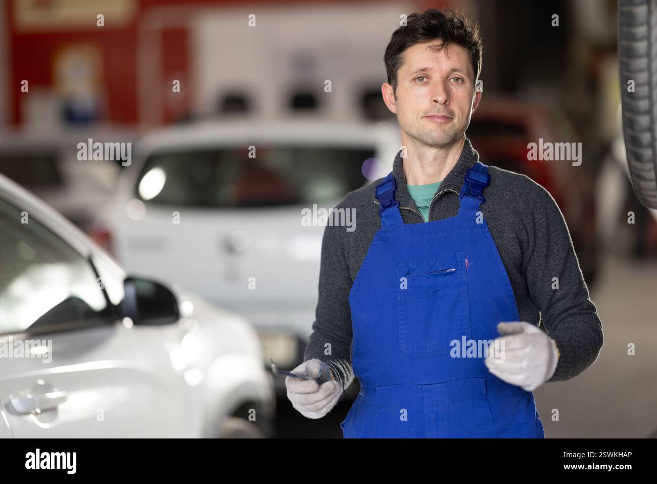 Service station man employee works in repair box, department Stock ...
