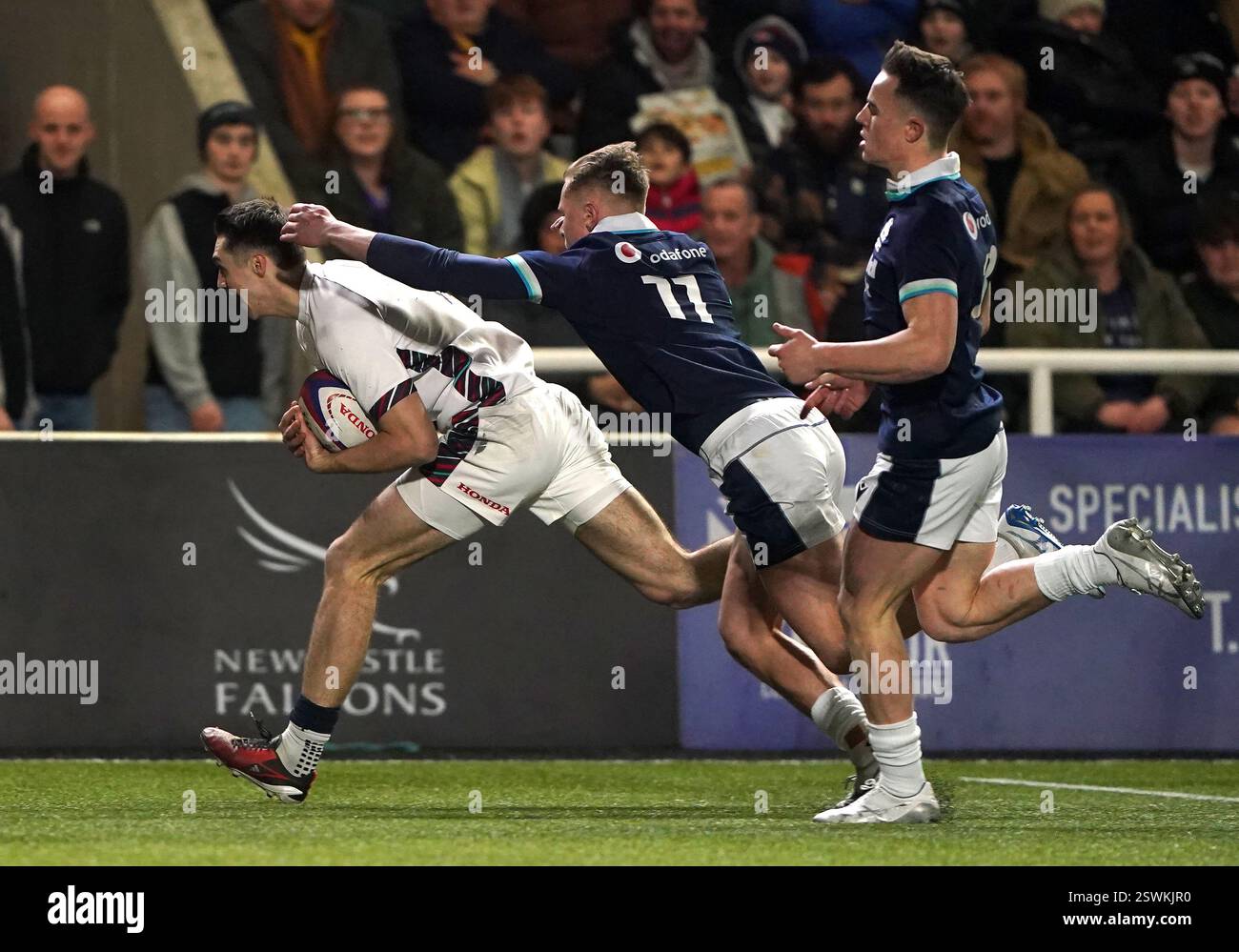 England's Campbell Ridl (left) evades Scotland's Fergus Watson to score ...