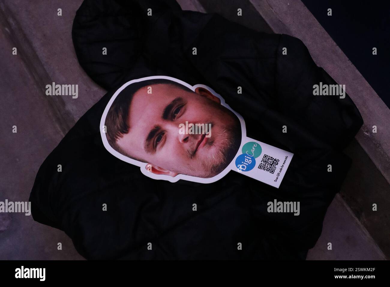 A Luke Littler mask during the Betfred Super League Round 2 match ...