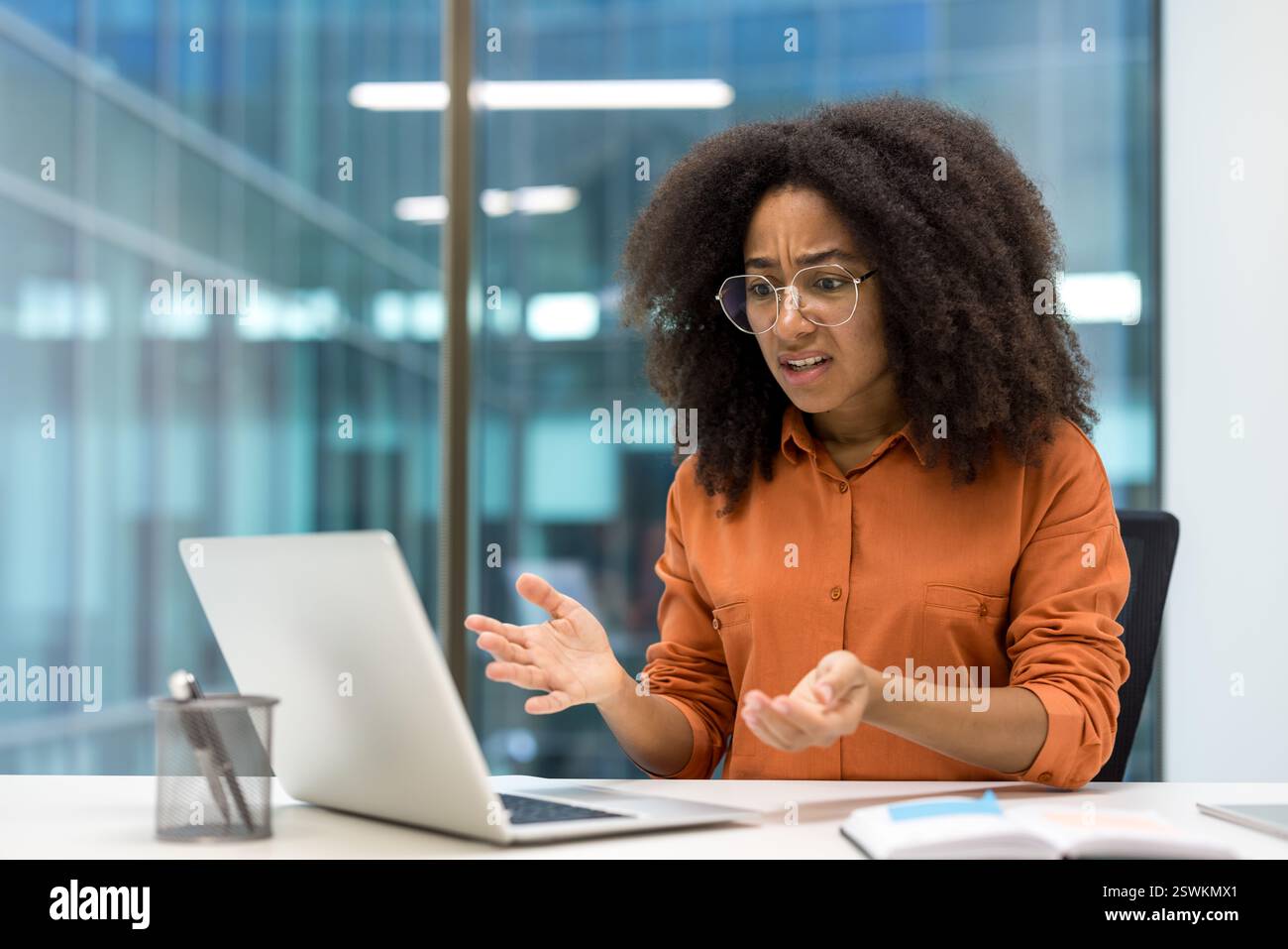 Angry and dissatisfied businesswoman looking at laptop screen. Employee ...