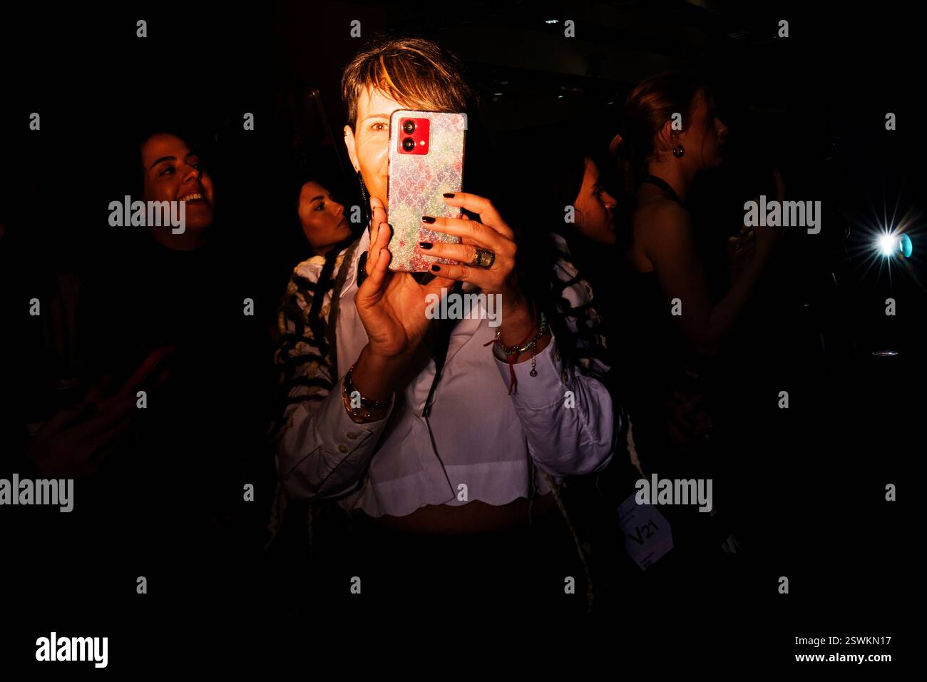 People take backstage snapshots during a fashion show by Spanish ...