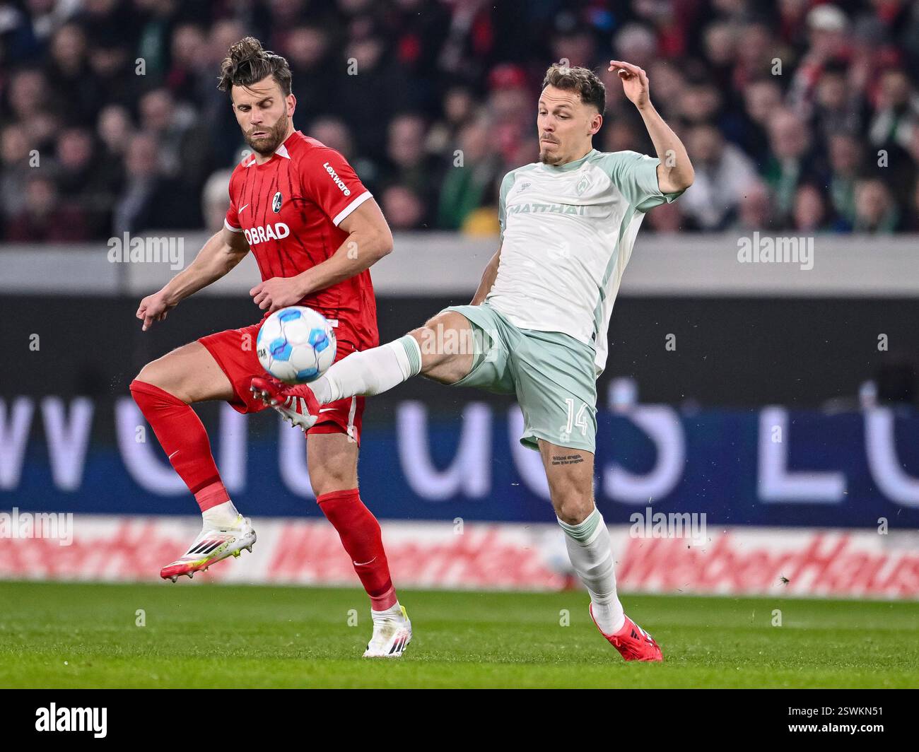 Freiburg's Lucas Höler, left, and Bremen's Senne Lynen in action during ...