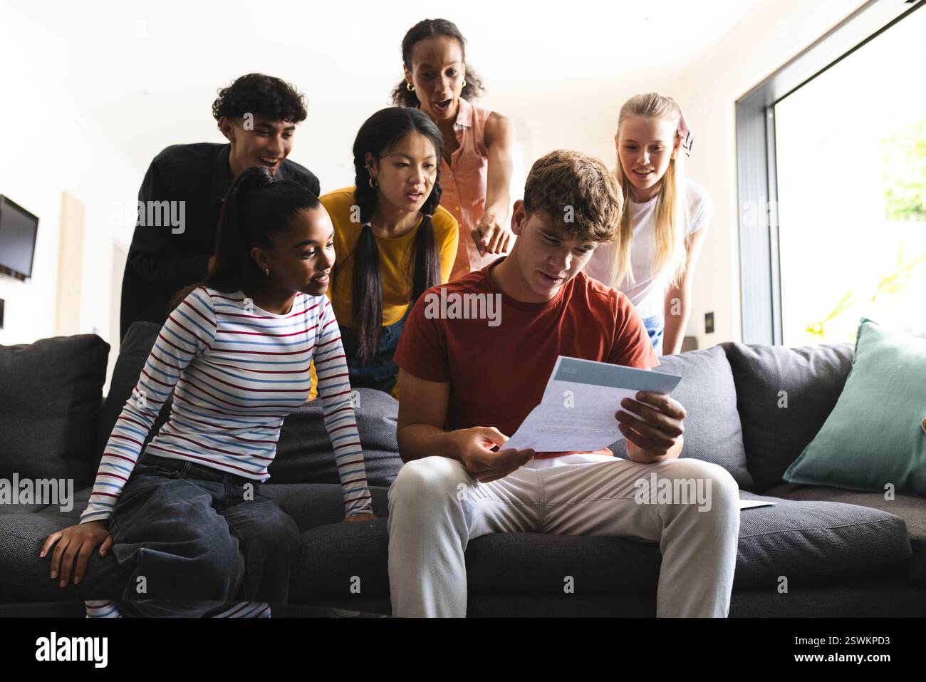 Reading acceptance letter, diverse teenagers celebrating success ...
