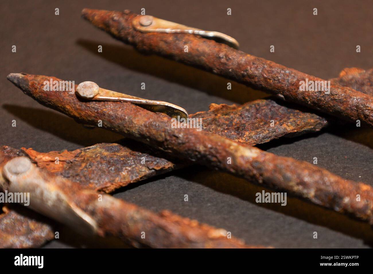Close-up of an old, rusty fishing trident with heavily corroded metal ...