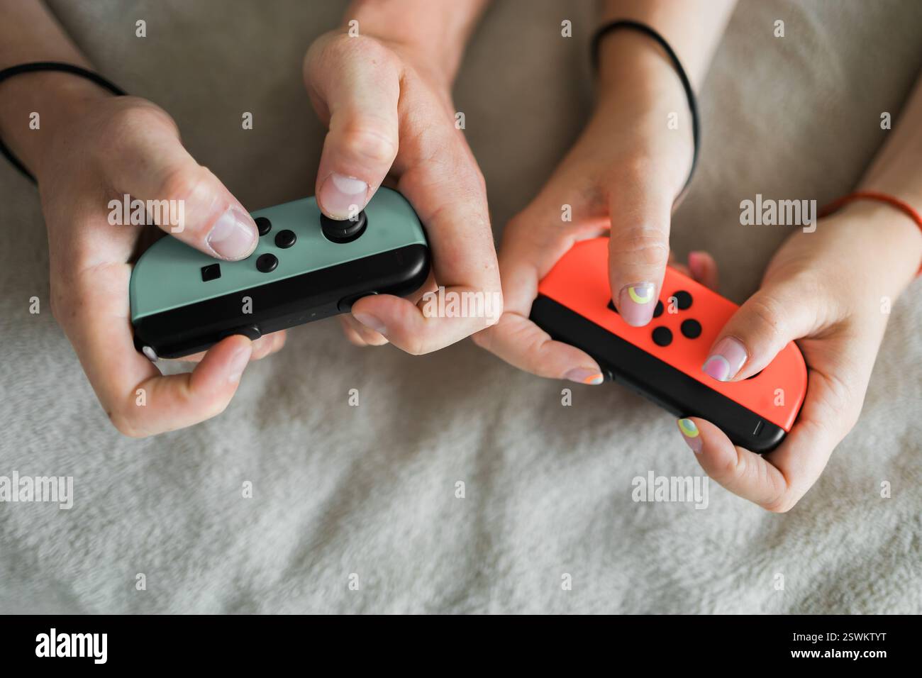 Woman and man playing on the video game console. Holding hands gamepad ...