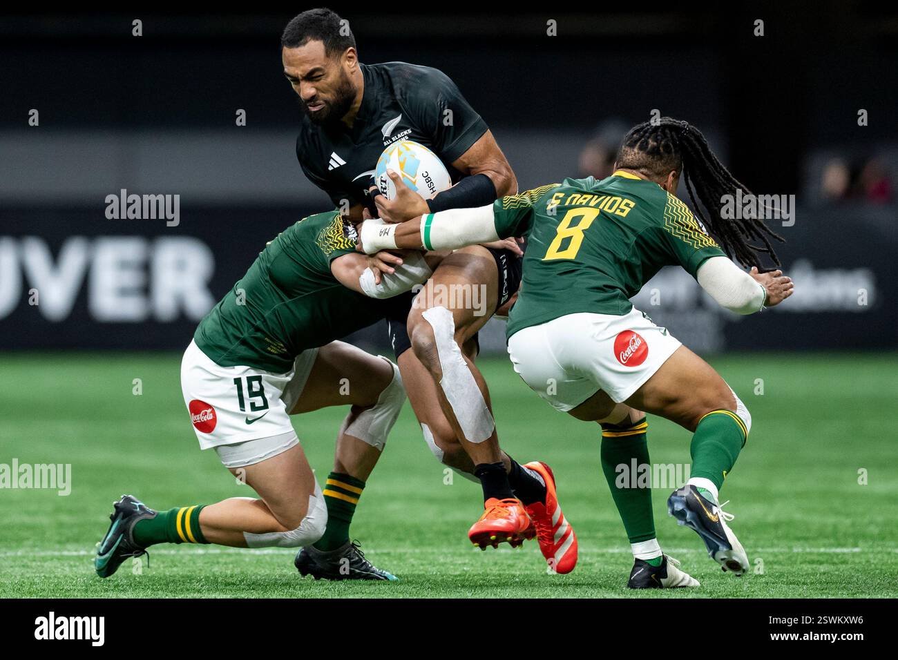 New Zealand's Sione Molia, center, runs through South Africa's David ...