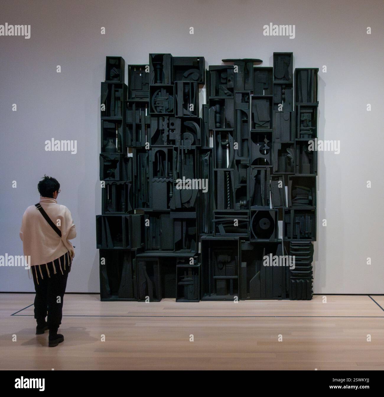 spectator looking at Louise Nevelson Sky Cathedral, Painted wood ...