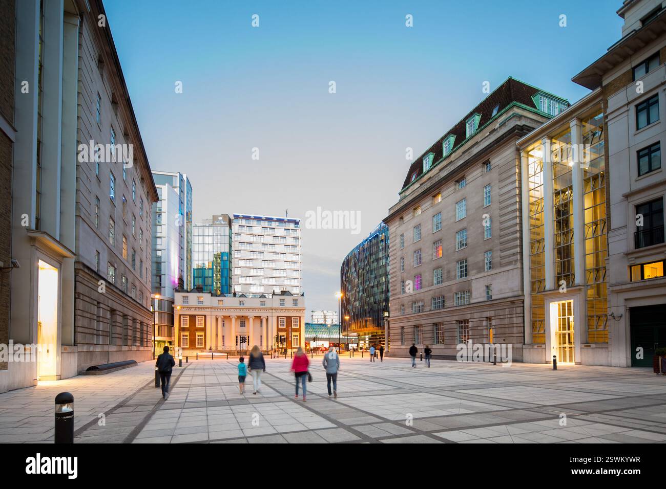 Pedestrians walk through the plaza outside the Forum Magnum Square and ...
