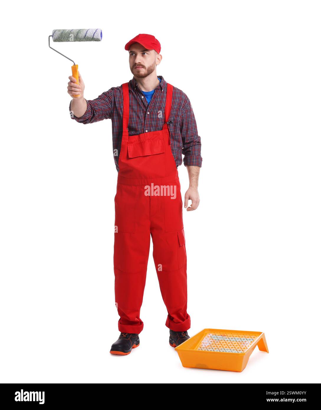 Professional painter with roller and tray working on white background ...