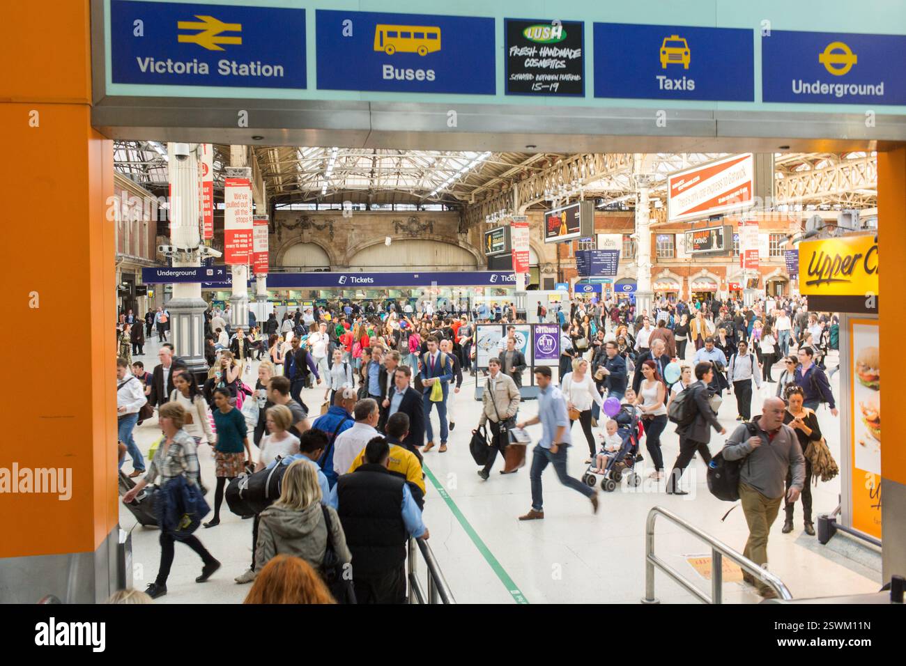 Victoria Station, London, UK. Commuters rush through the busy concourse ...