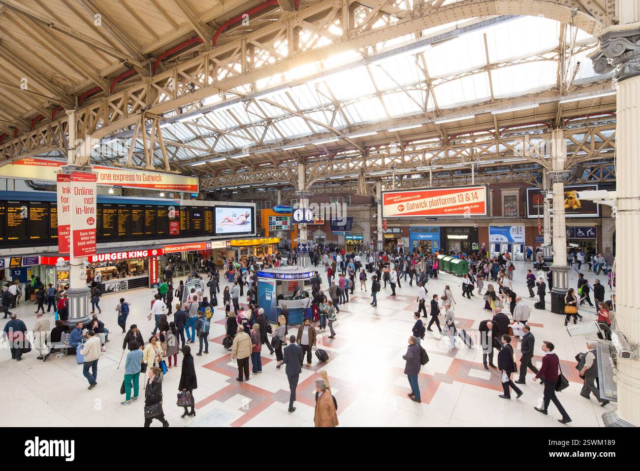London Victoria Station. Commuters and travelers navigate the station's ...