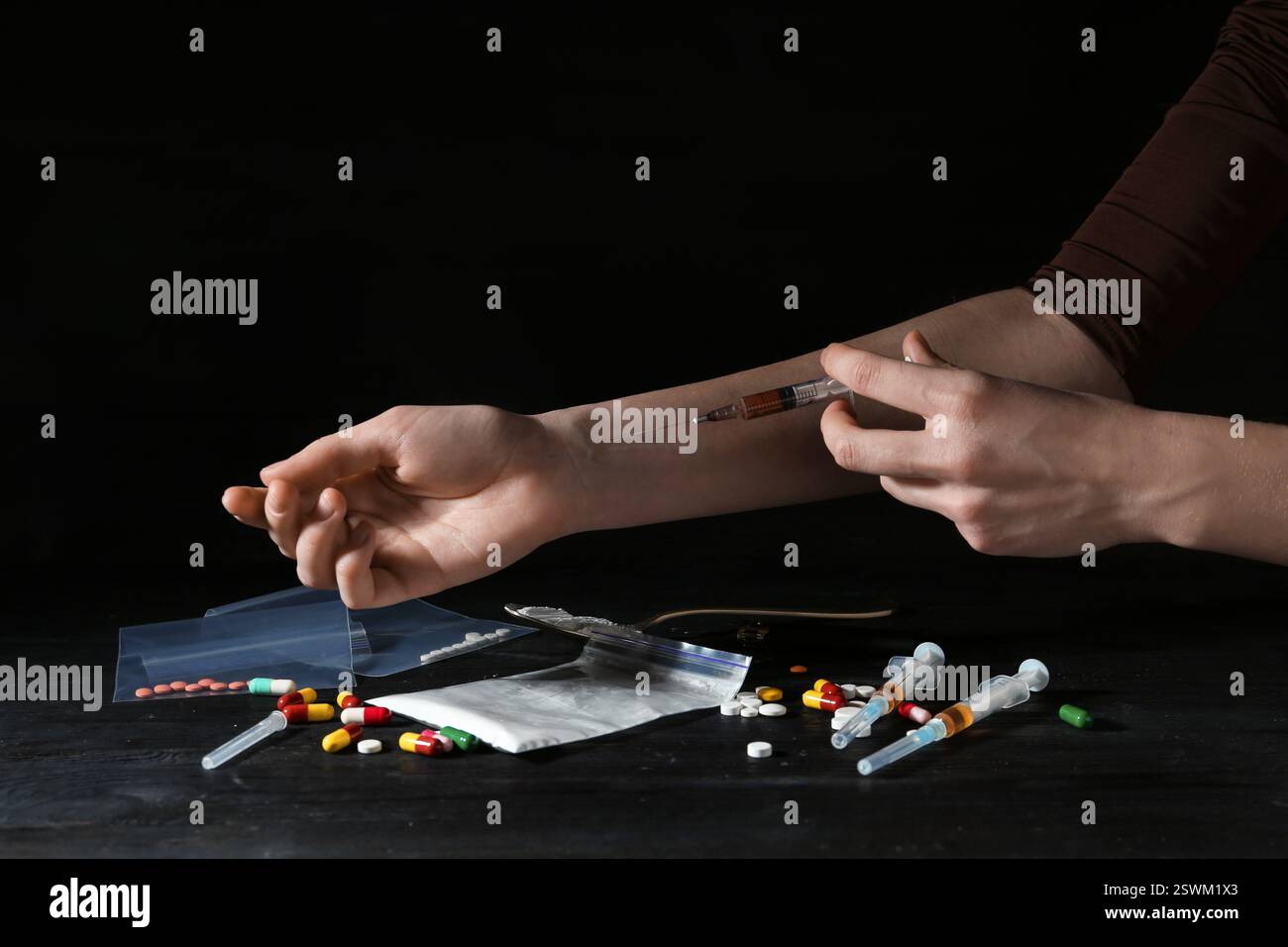 Drug addiction. Woman with syringe against dark background, closeup ...