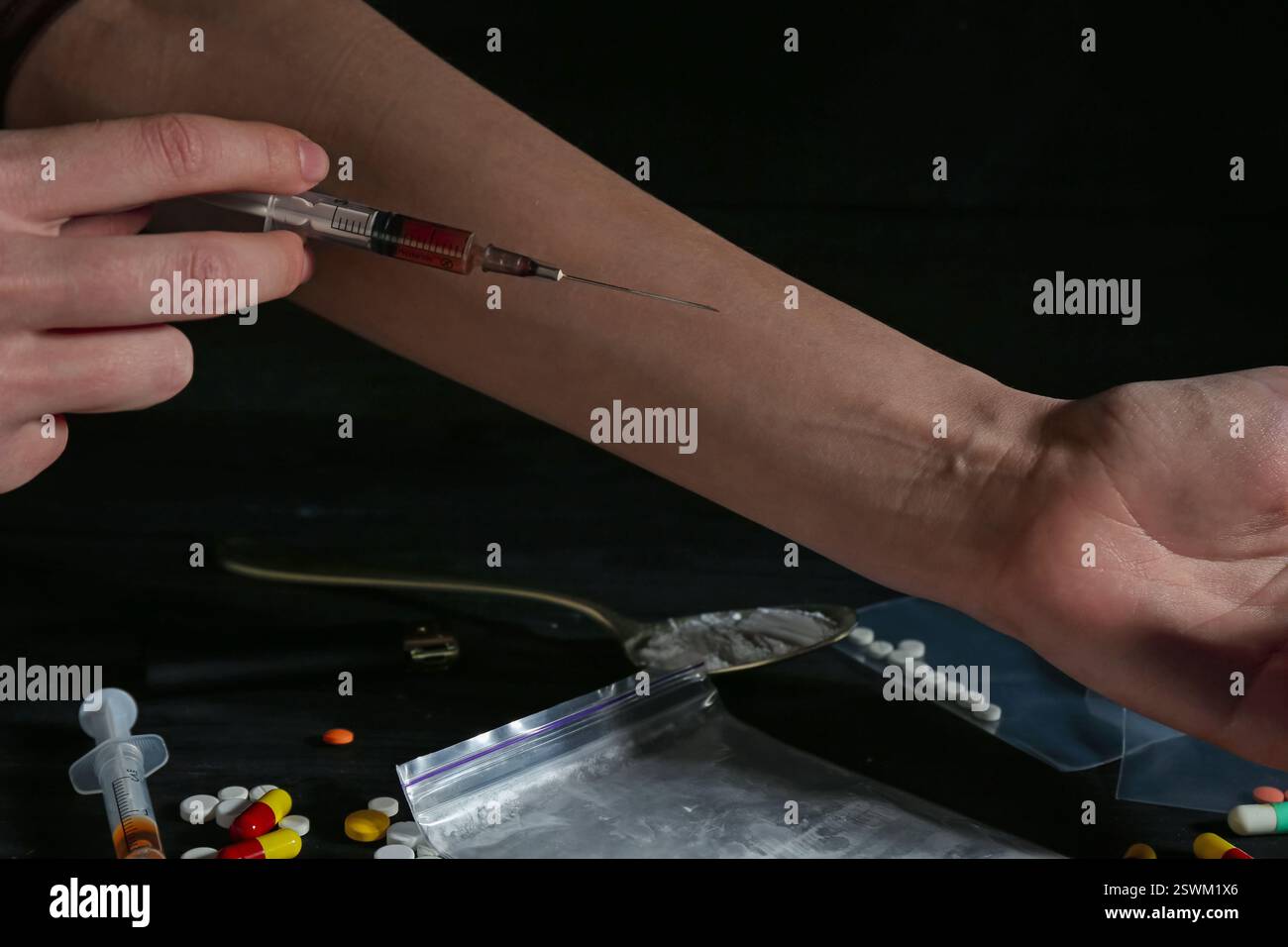 Drug addiction. Woman with syringe against dark background, closeup ...