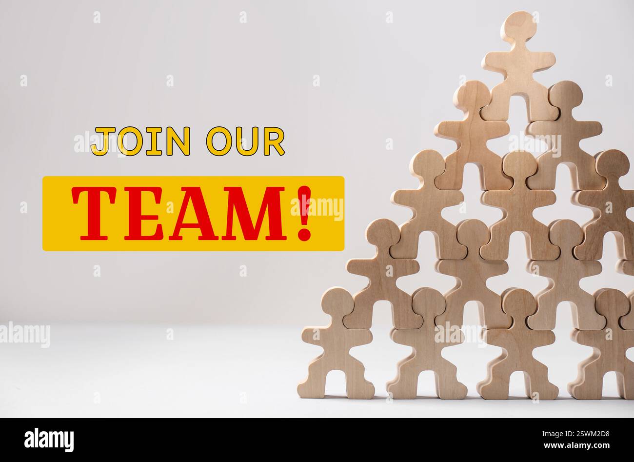 Join our team! Pyramid of wooden human figures on white table. Human ...