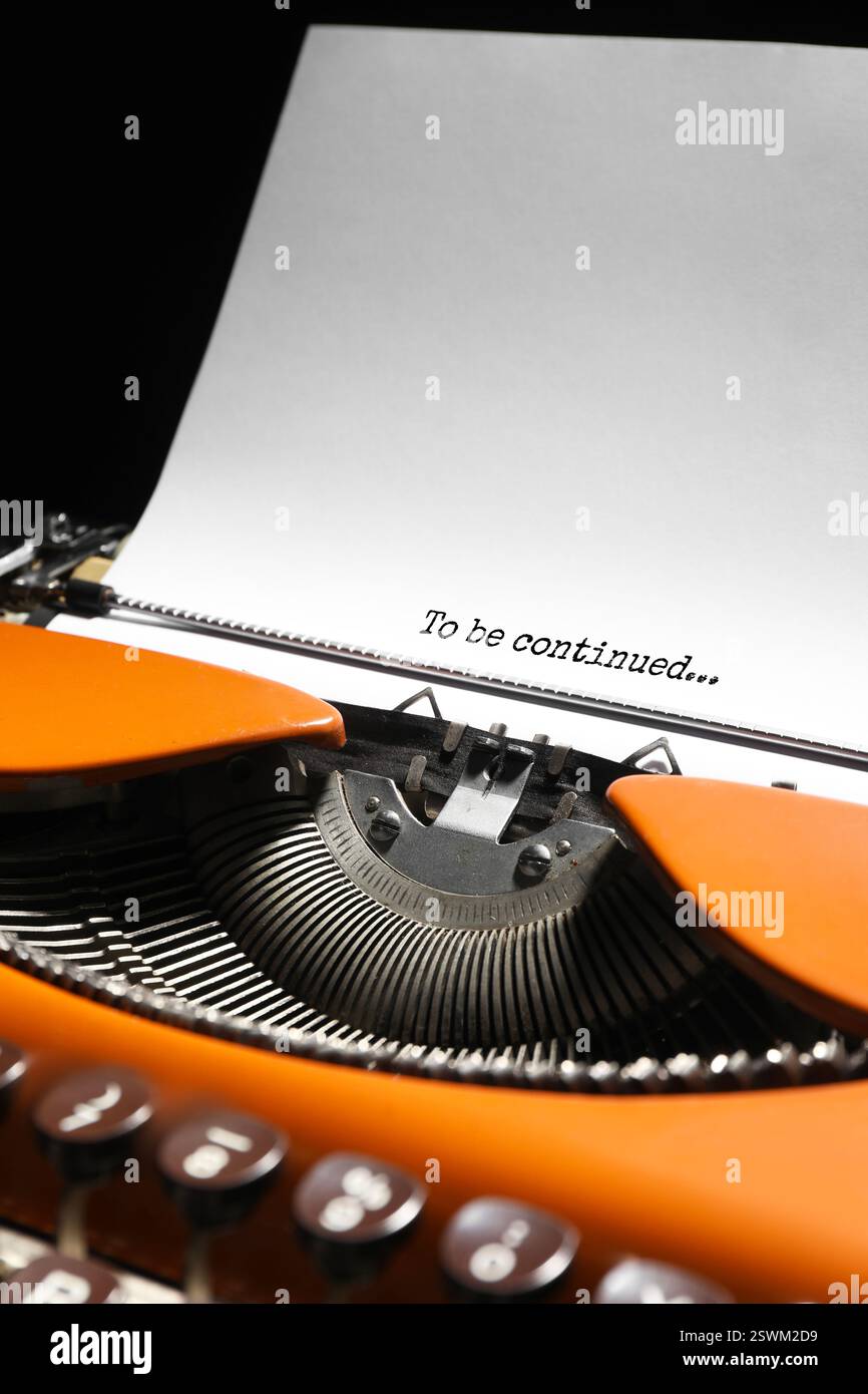 Typewriter with sheet of paper, closeup. Typed text To Be Continued ...