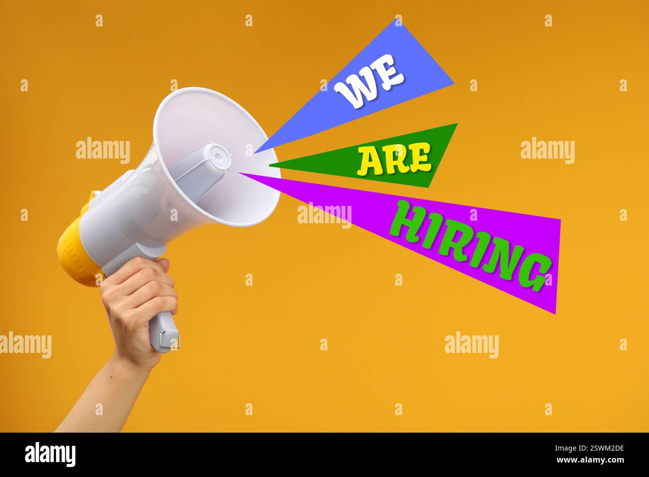 we-are-hiring-words-coming-out-of-megaphone-in-woman-s-hand-on-orange