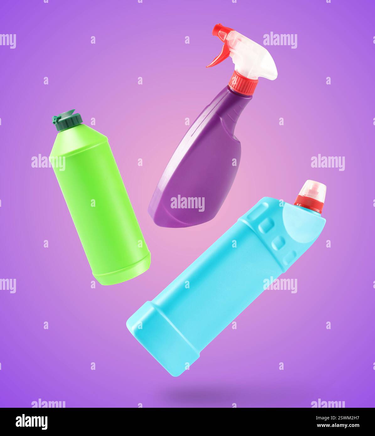 Different cleaning products in air on violet background Stock Photo - Alamy