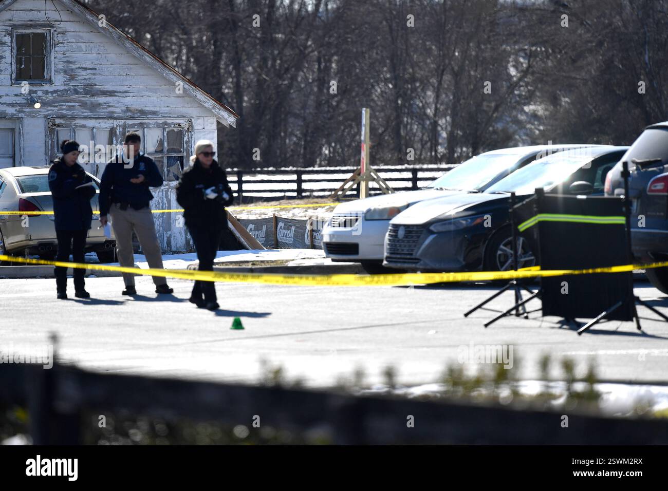 Detectives with the Louisville Metro Crime Scene unit examine the scene ...