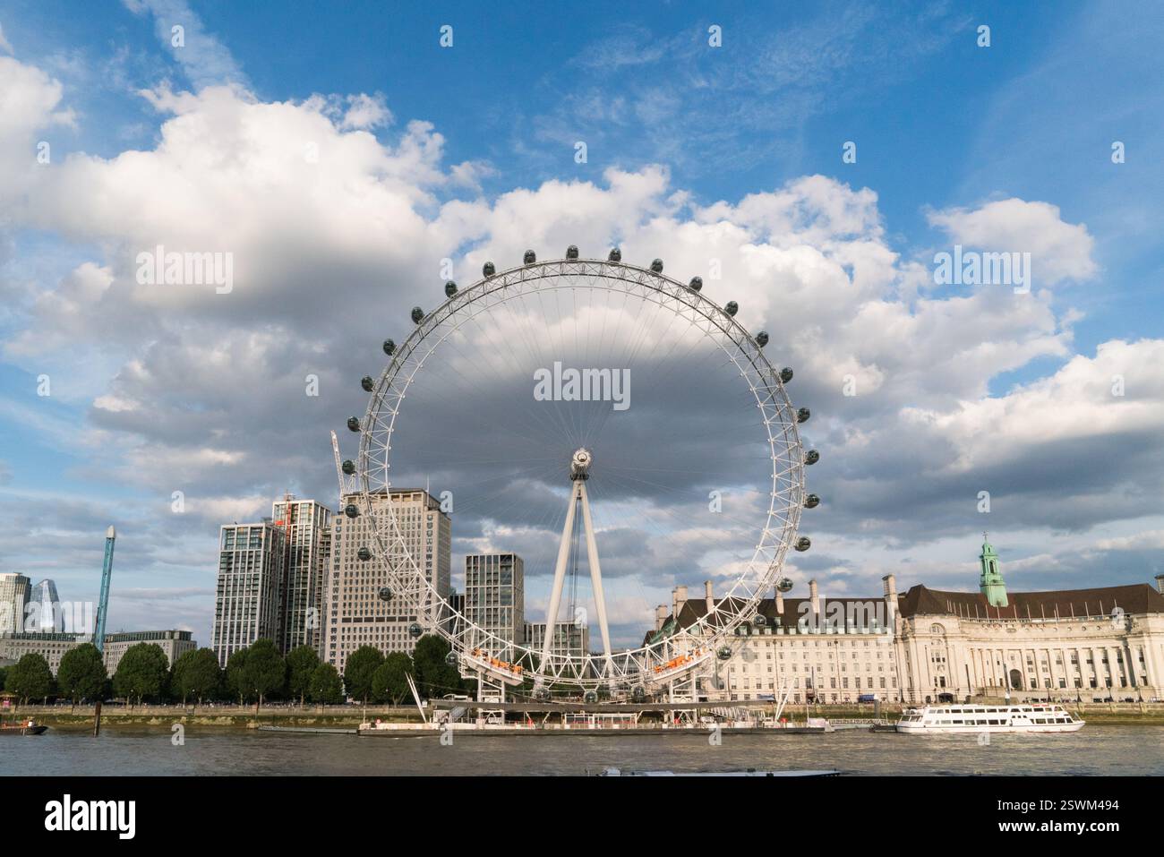 London Eye, a giant Ferris wheel, over the River Thames, with modern ...