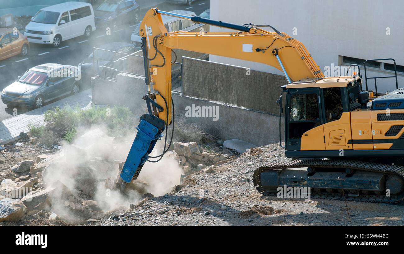 Demolition hammer in use on building caterpillar Stock Photo - Alamy
