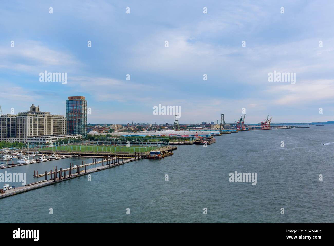 Vibrant harbor shows container ships alongside marina downtown Brooklyn ...