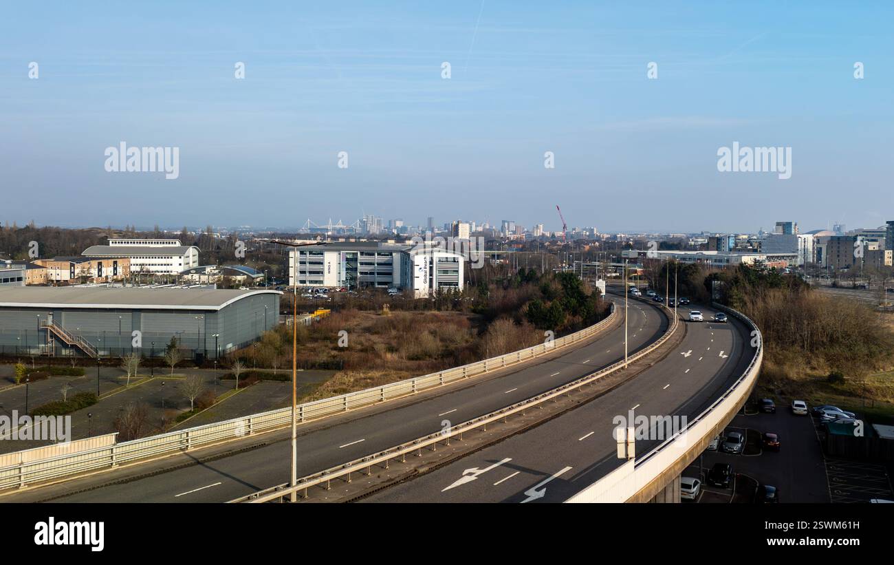 Aerial view of a highway curving through an industrial area with ...