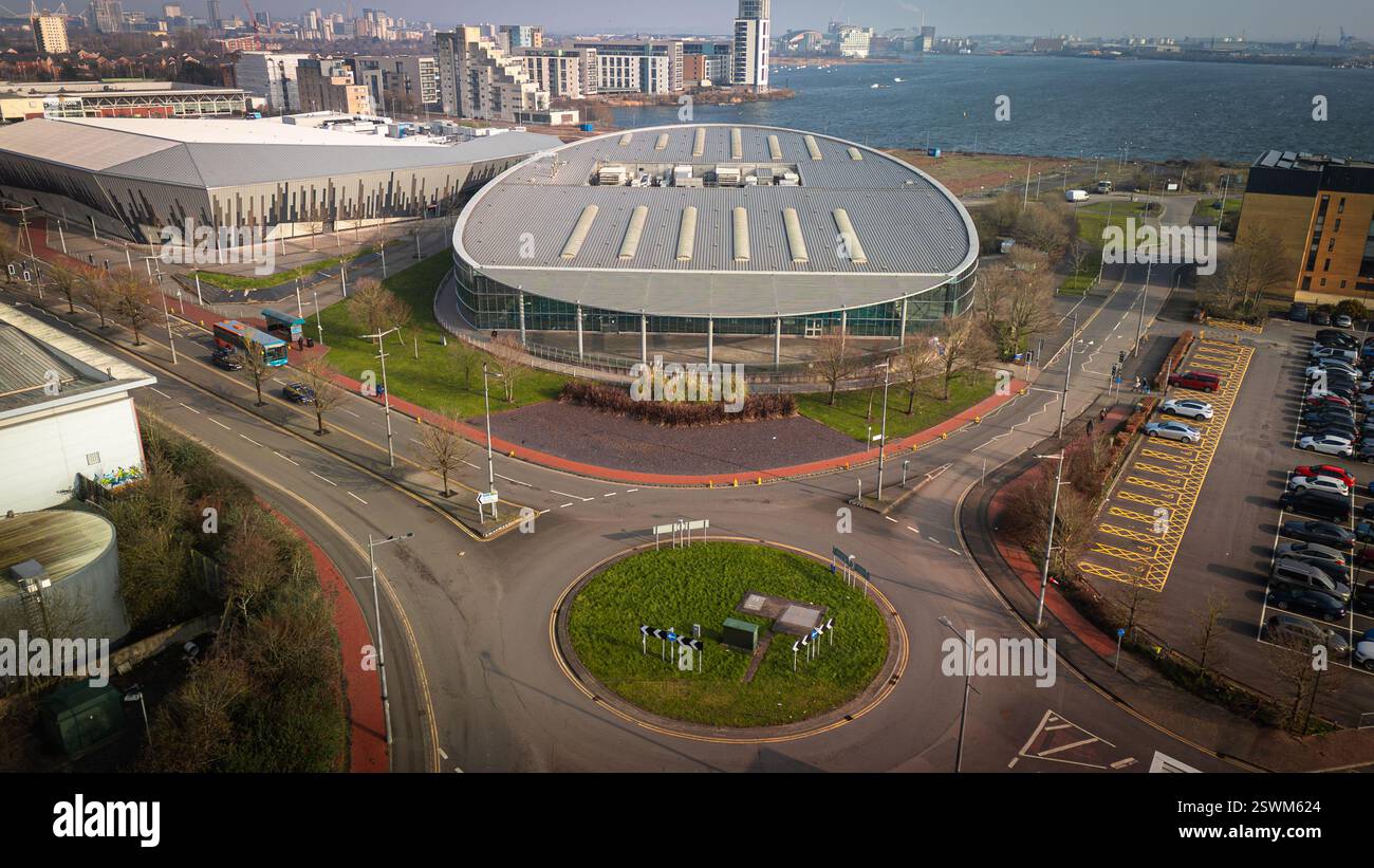 Aerial view of a modern circular building near a waterfront, surrounded ...