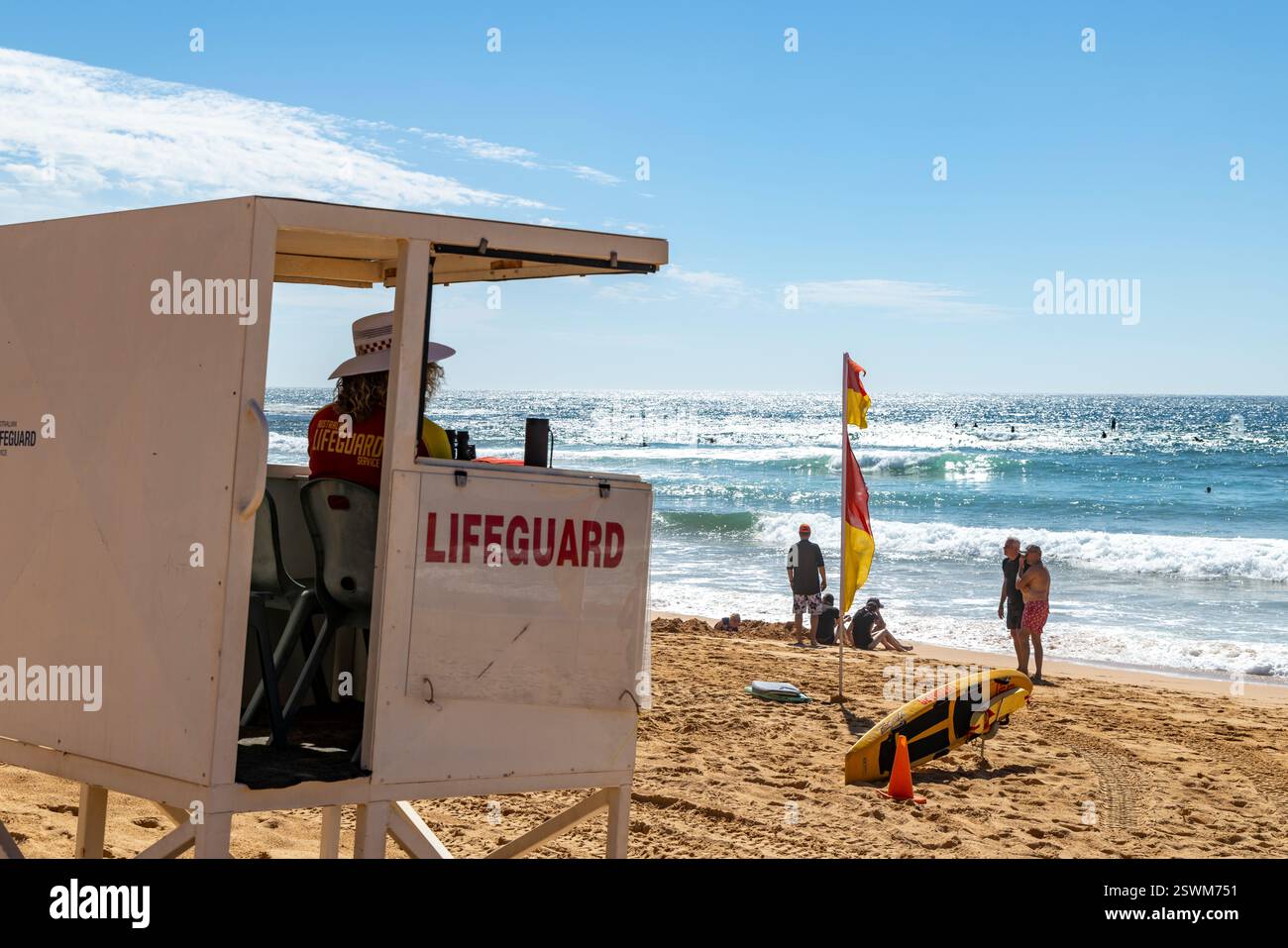 Surf rescue lifeguard looks over people swimming at Mona Vale beach in ...
