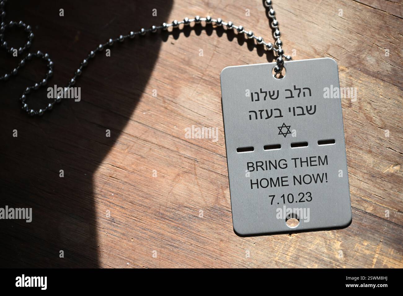 Dog tag with the words "Bring them home now!" in English and Hebrew in ...