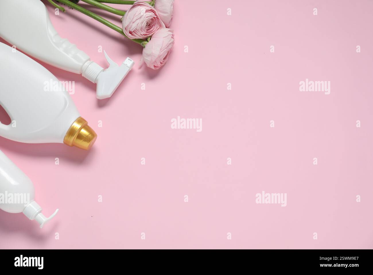 Spring cleaning. Bottles with detergents and flowers on pink background ...