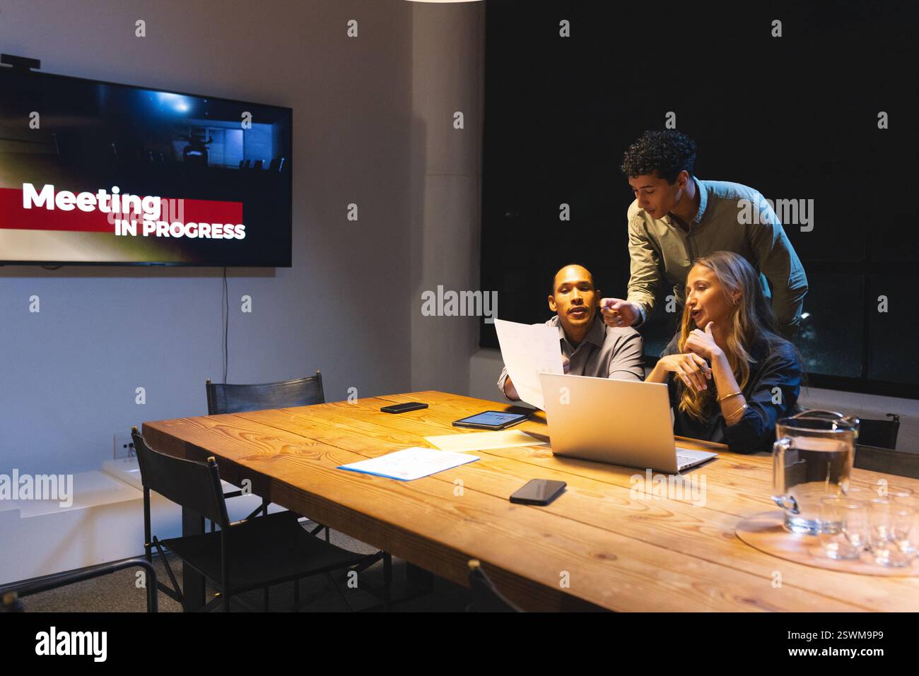 In conference room, diverse professionals collaborating on project ...