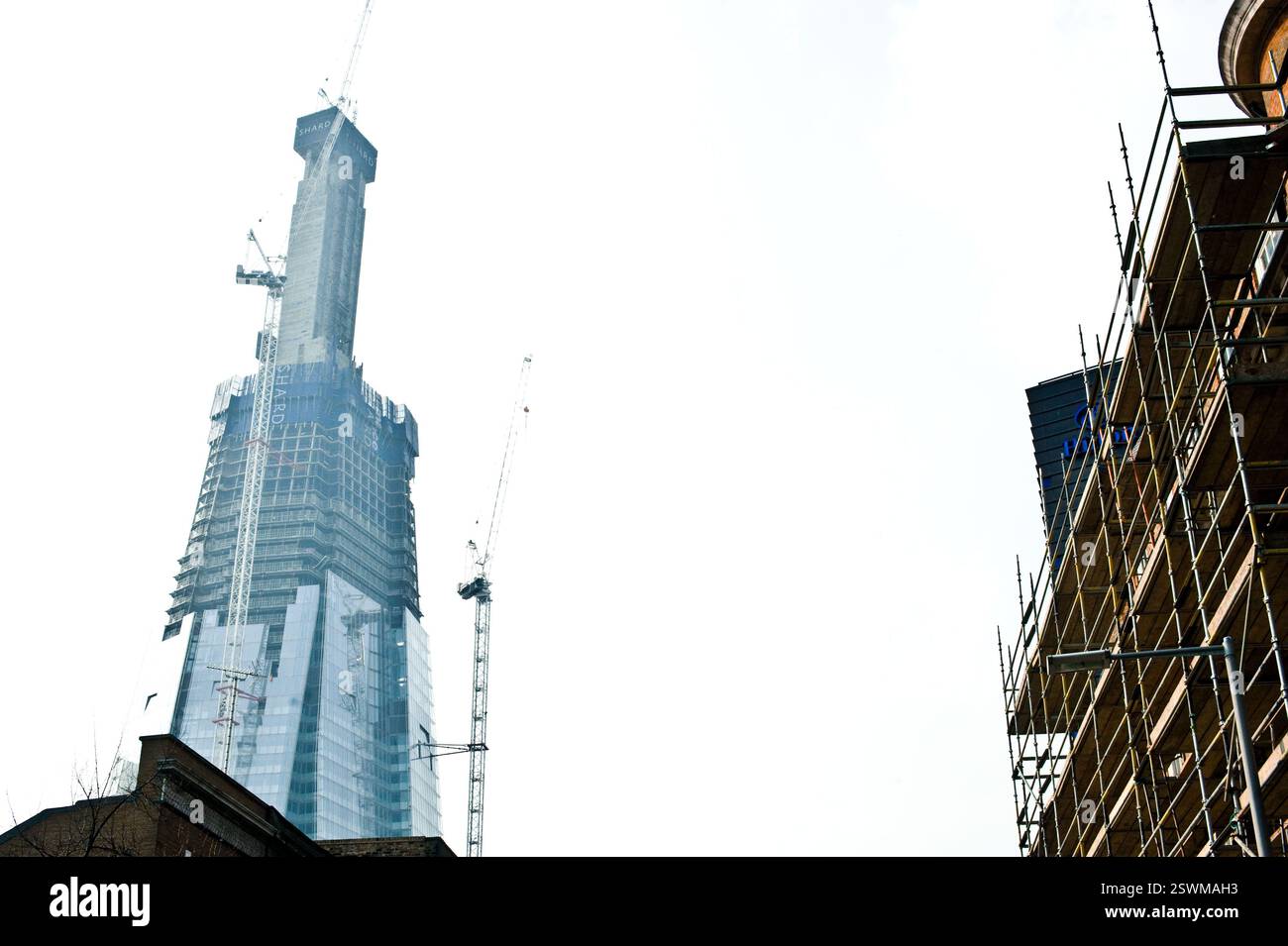 Construction of The Shard, London, UK. Scaffolding on adjacent building ...