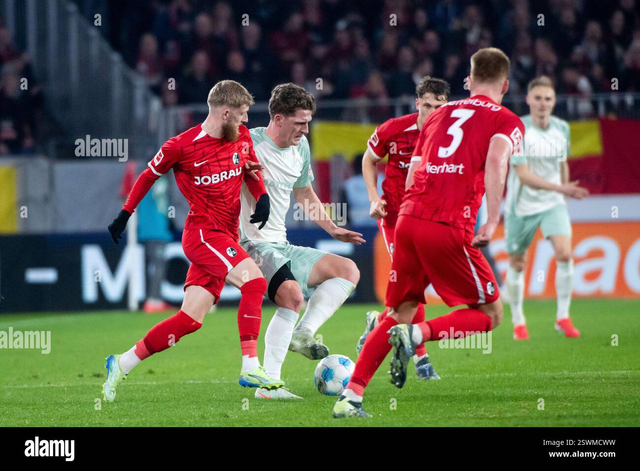 Jens Stage (Werder Bremen, #06) im Zweikampf mit Jan-Niklas Beste (SC Freiburg, #19), davor ...