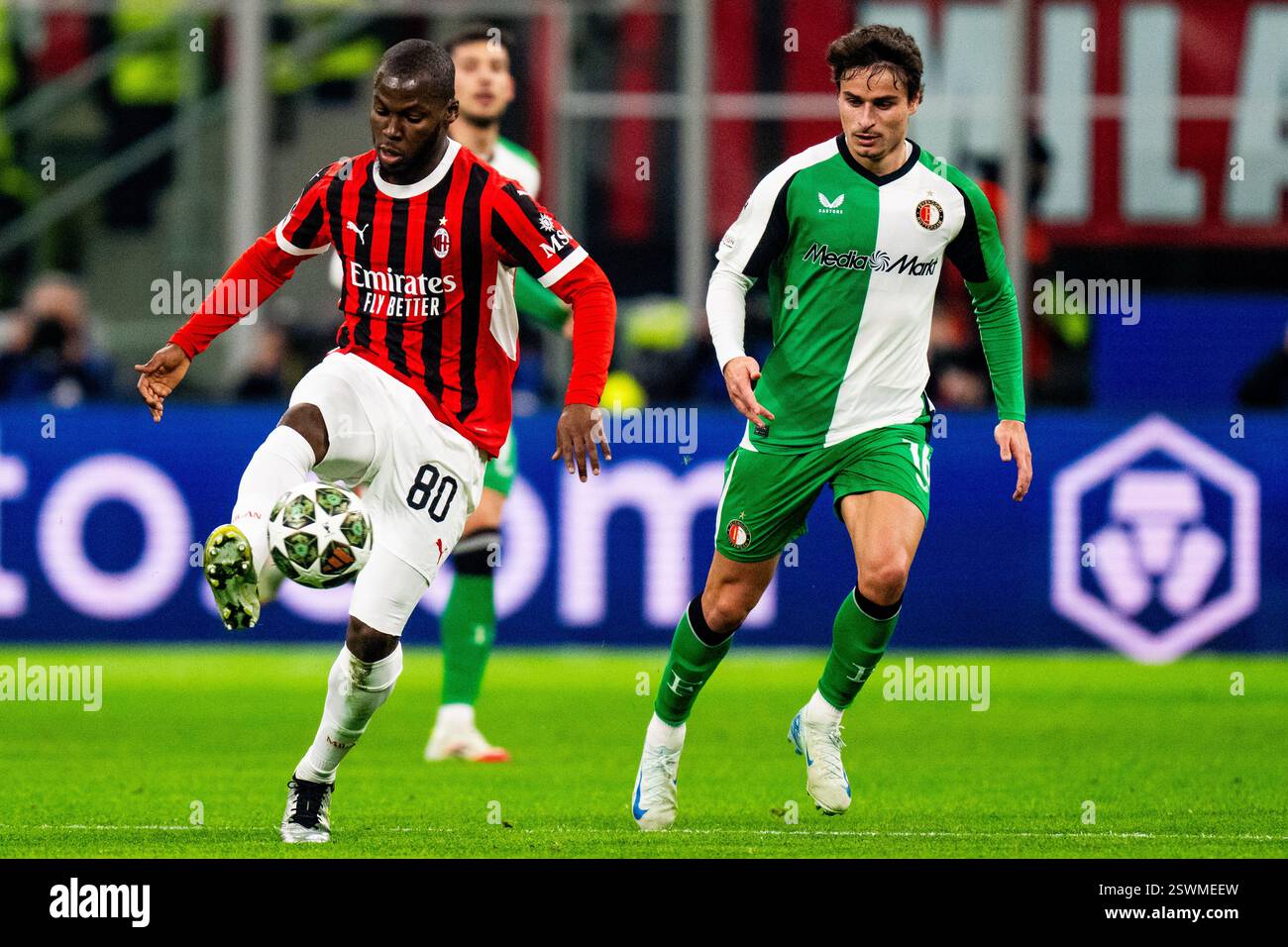 Milan, Italy. 18th Feb, 2025. Milan - Yunus Musah of AC Milan, Hugo Bueno of Feyenoord during ...