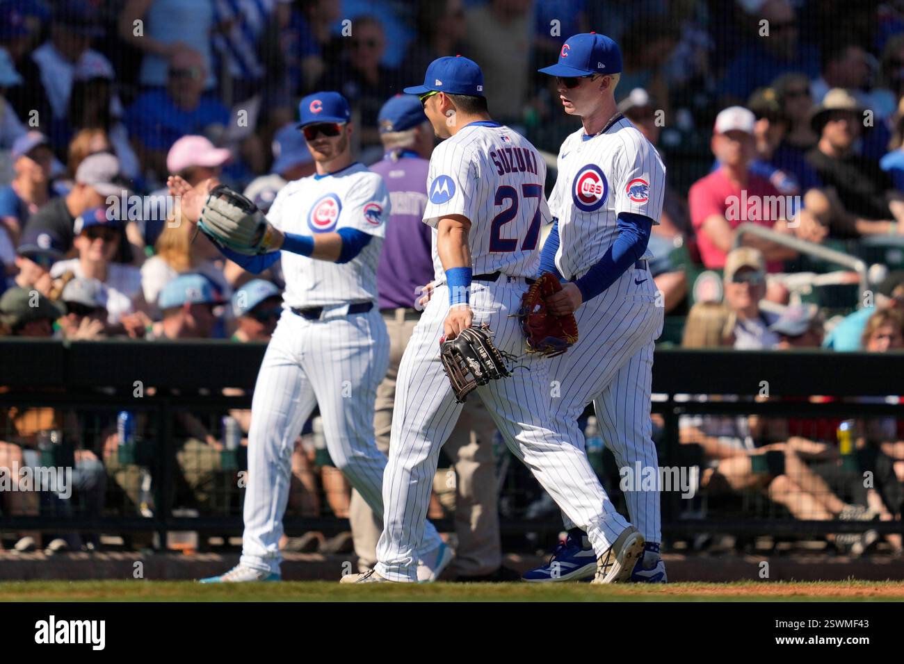 Chicago Cubs right fielder Seiya Suzuki (27) is greeted by center ...