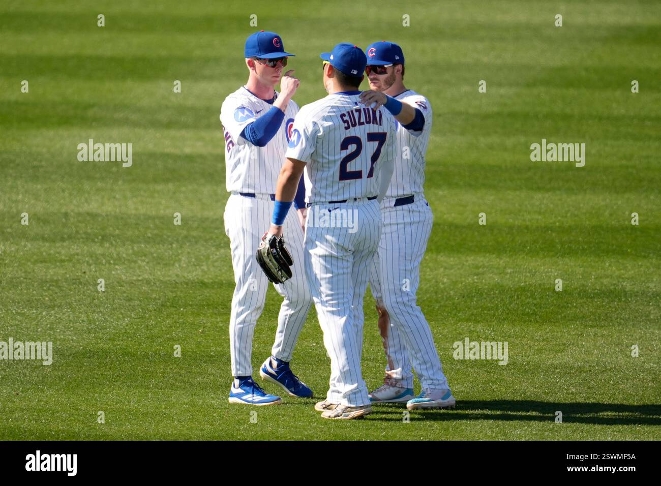 Chicago Cubs right fielder Seiya Suzuki (27) talks with center fielder ...