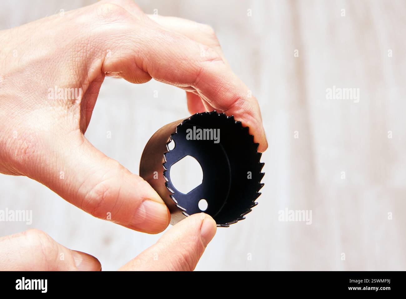 Hand holding circular hole saw with serrated cutting edges Stock Photo ...