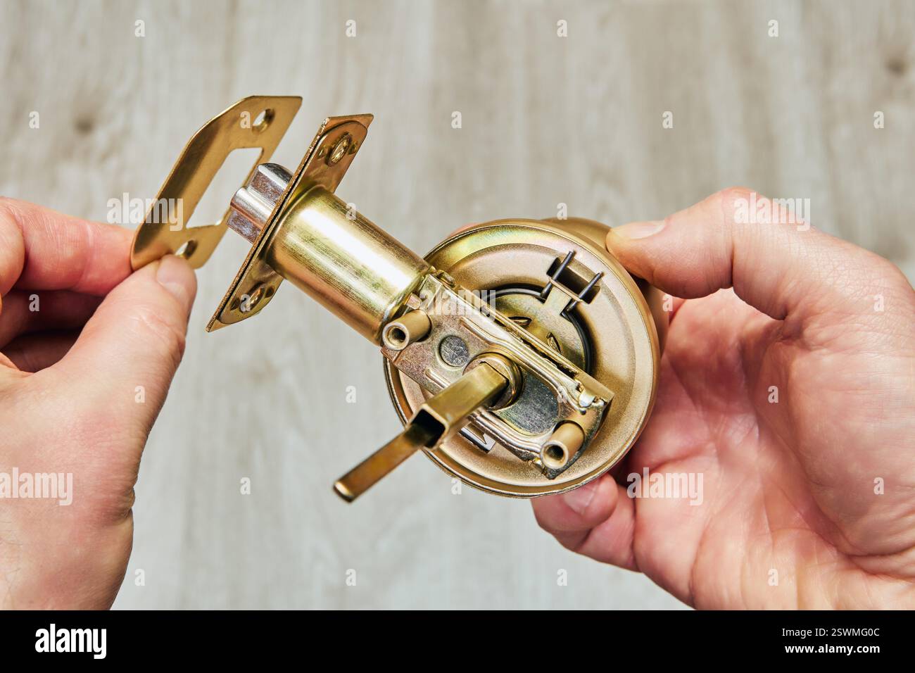 Brass doorknob being built piece by piece focusing on the spindle ...