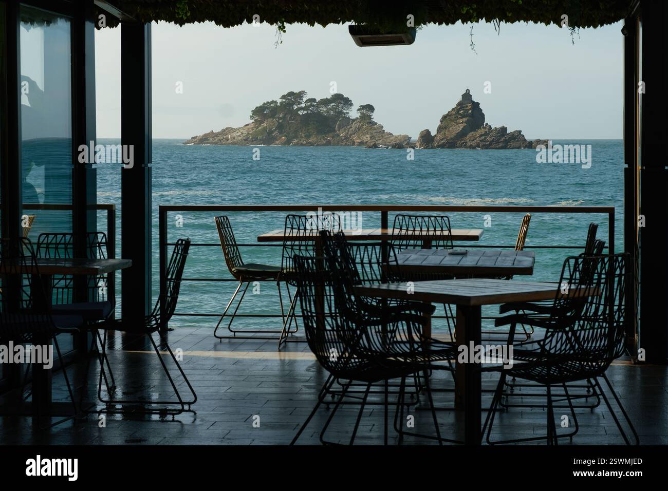 Seaside cafe with ocean view and fortress Stock Photo - Alamy