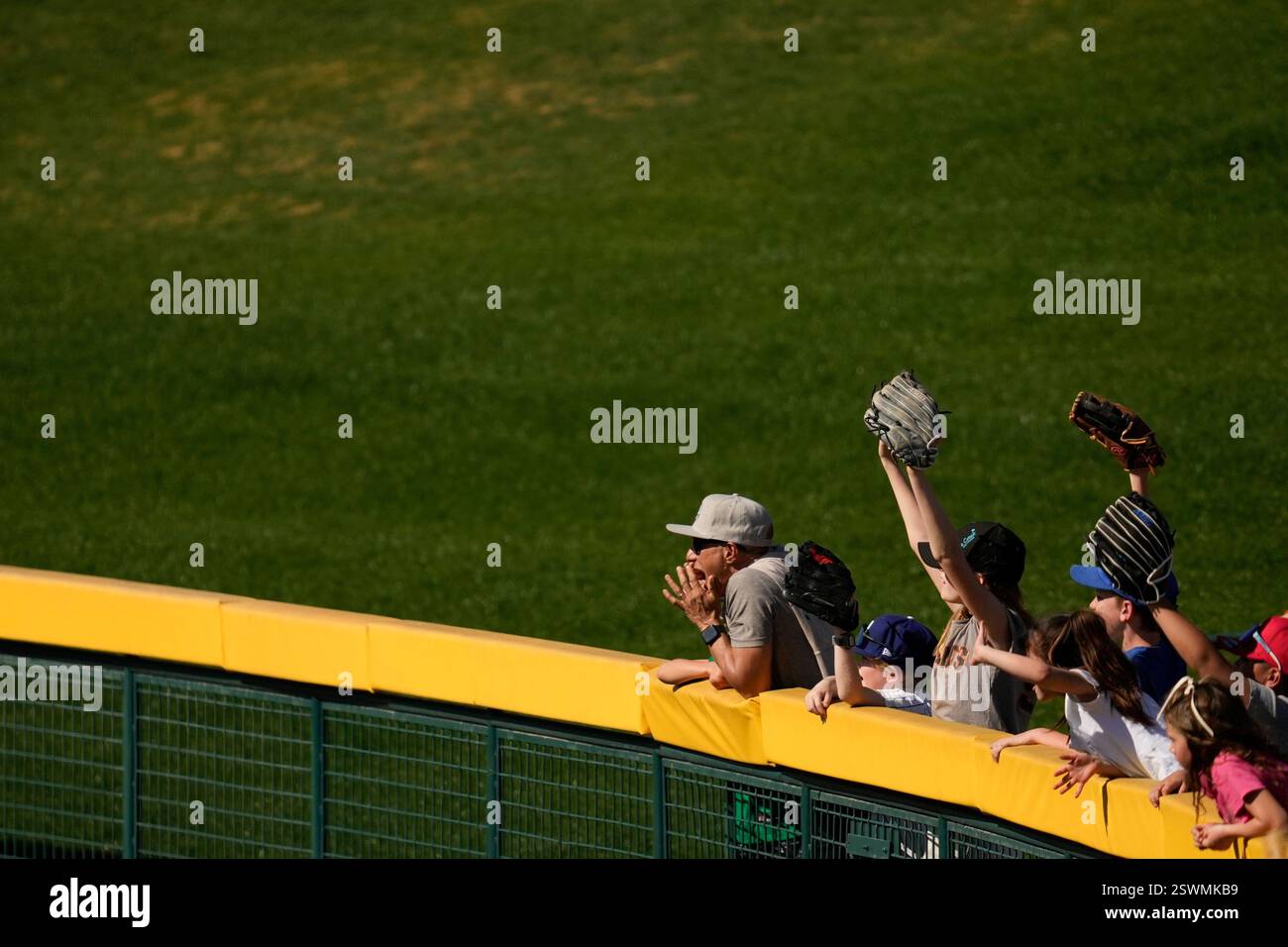 Fans yell to players during the fourth inning of a spring training ...