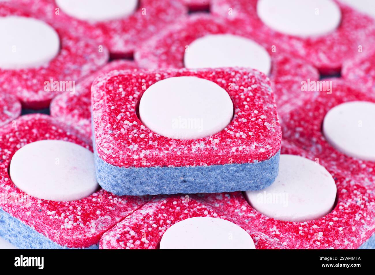 Brightly colored dishwasher soap tablets are arranged together ...