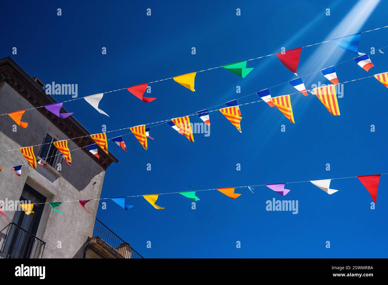 Vibrant flags of Catalonia and France and in various colors wave in the ...