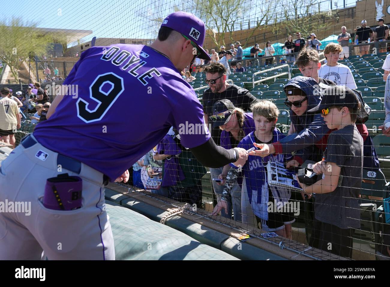 Colorado Rockies outfielder Brenton Doyle (9) gives autographs to fans ...