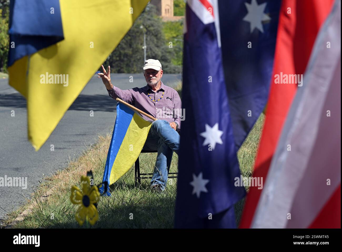 Canberra, Australia. 22nd Feb, 2025. Protesters wave Ukrainian flags ...