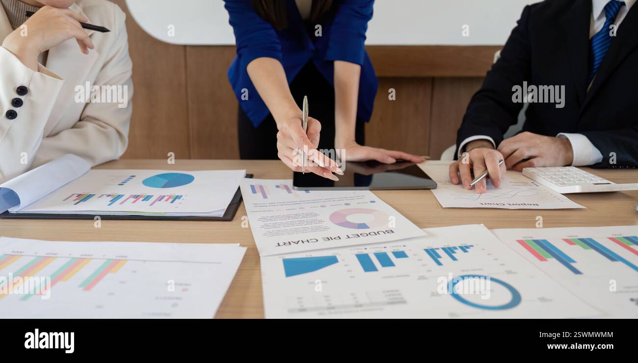 Business team analyzing budget pie chart and data reports during a ...