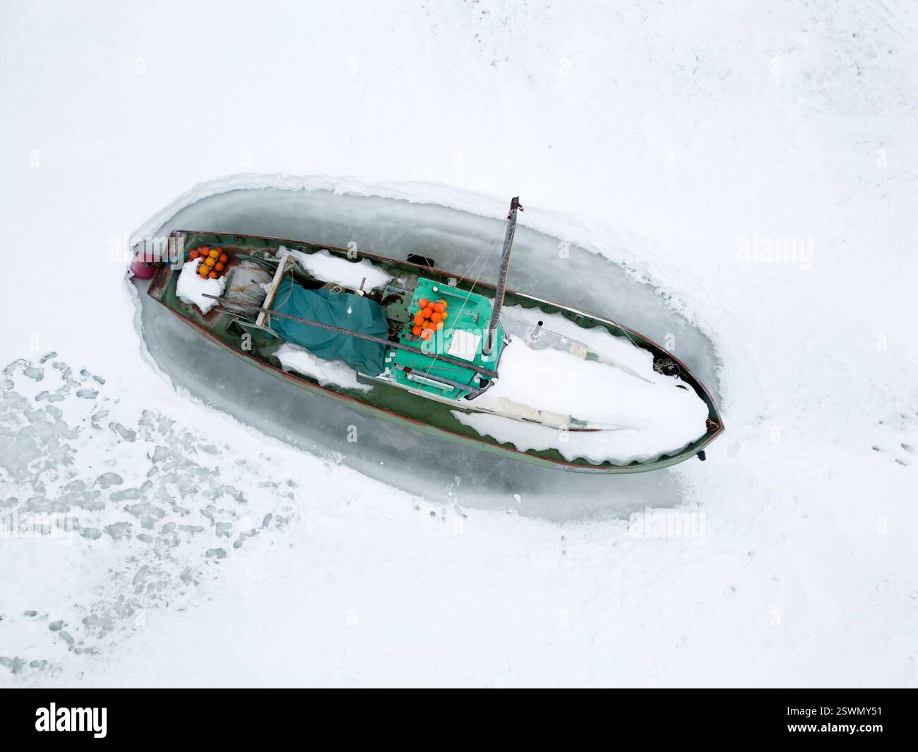 Aerial view of a fishing boat in a frozen lake. Lake Inari, Finland ...